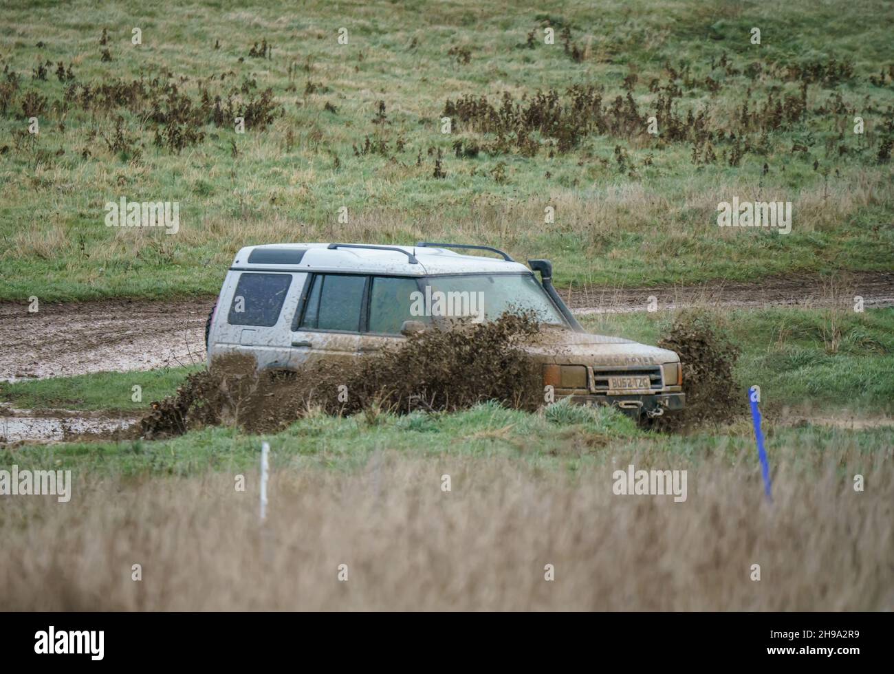 Land Rover Discovery II 2 4x4 off-road vehicle driving across mud and ...