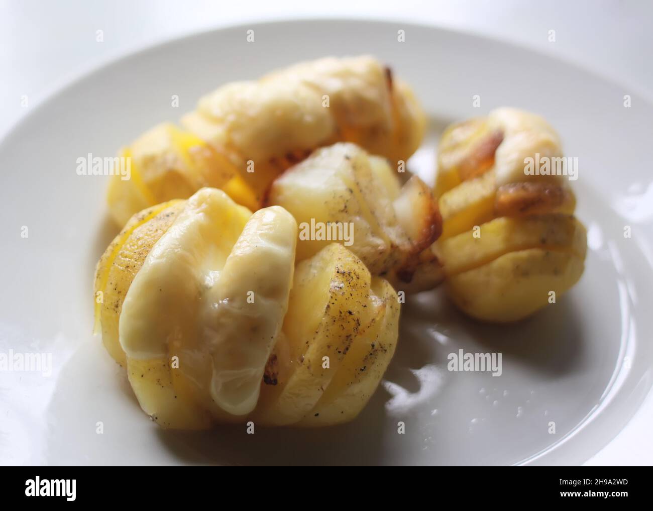 Baked potatoes with meat and cheese Stock Photo - Alamy