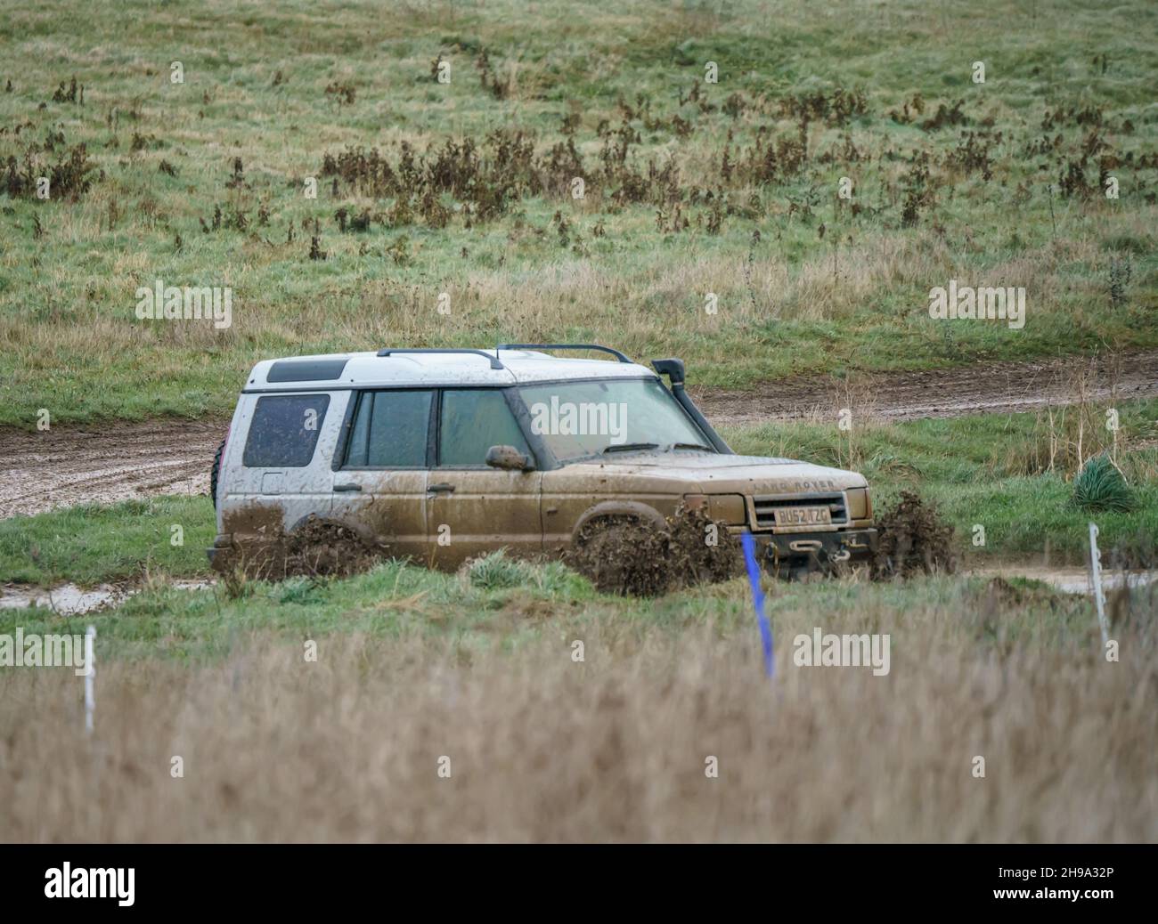 Land Rover Discovery II 2 4x4 off-road vehicle driving across mud and ...