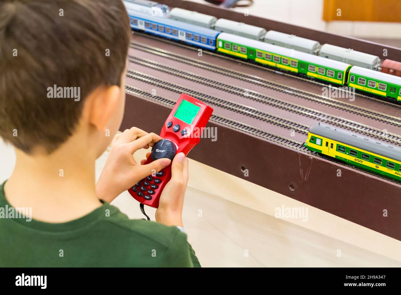 Boy child operating locomotive with Roco 10810 Z21 multiMAUS device at ...