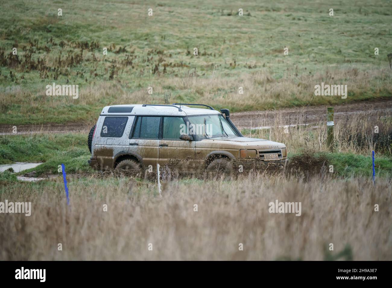 Land Rover Discovery II 2 4x4 off-road vehicle driving across mud and ...
