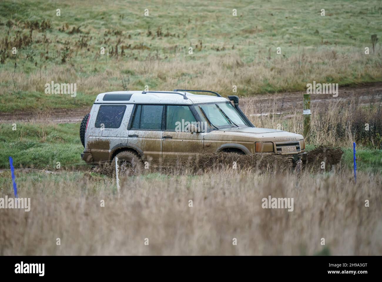4x4 off-road vehicles driving across mud and water-logged terrain ...