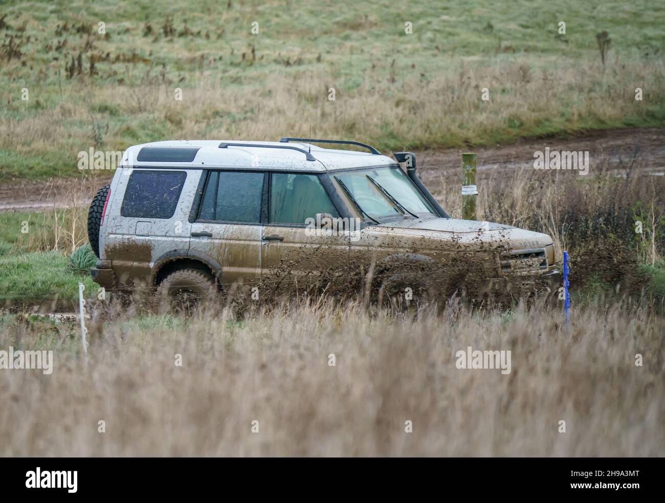 Land Rover Discovery II 2 4x4 off-road vehicle driving across mud and ...