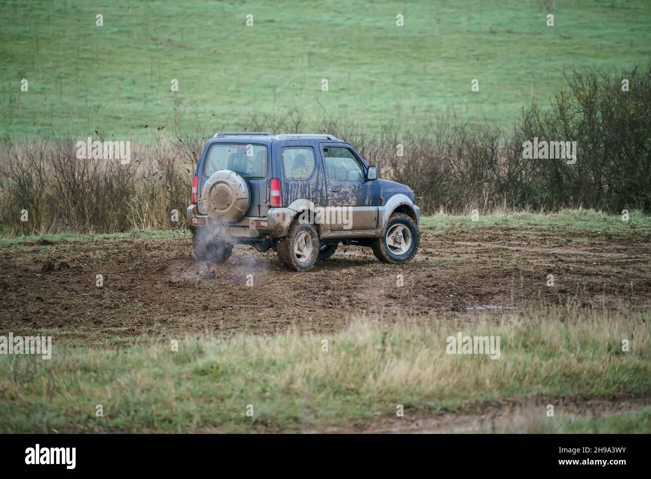 4x4 off-road vehicles driving across mud and water-logged terrain ...