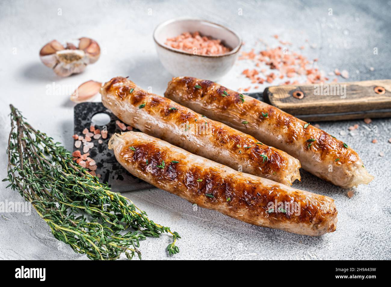 Grilled Bockwurst and Bratwurst meat sausages on a cleaver. White ...