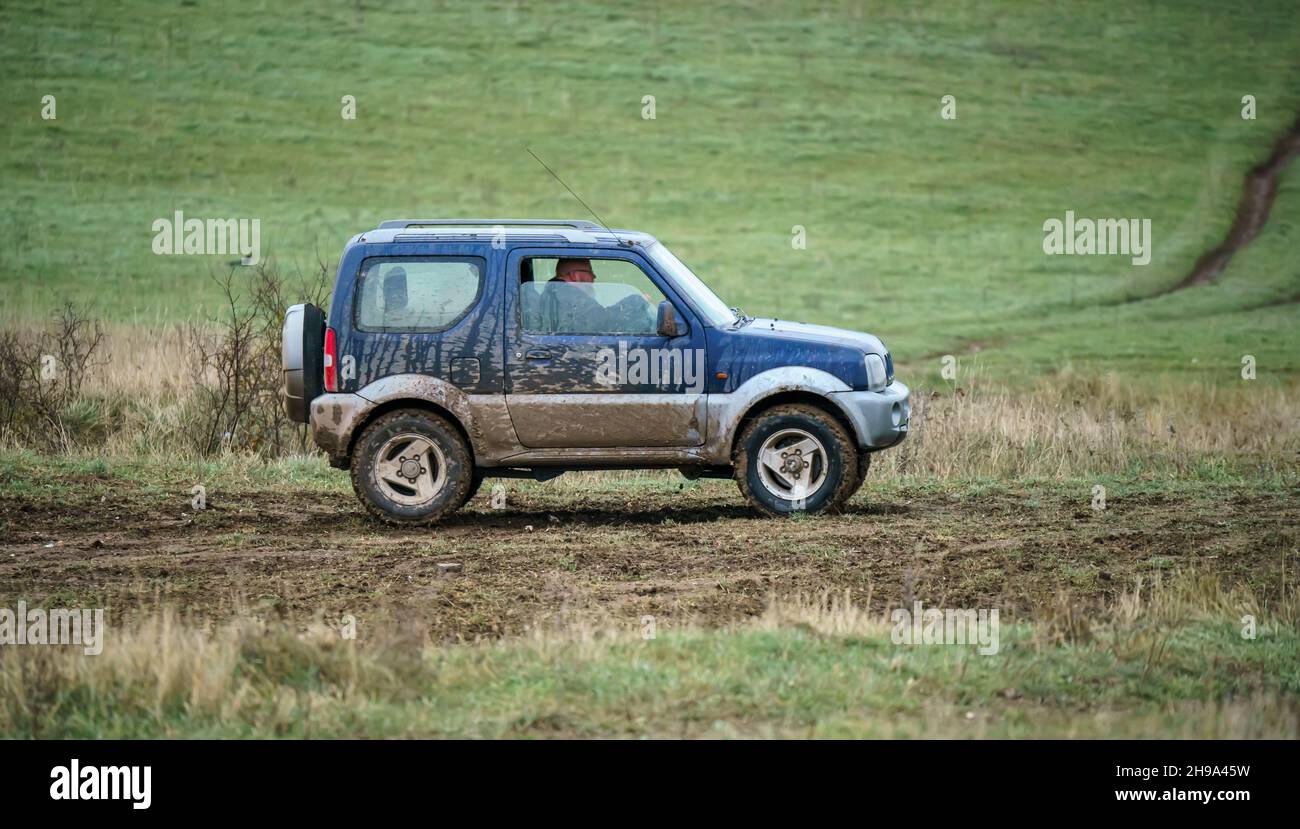 4x4 off-road vehicles driving across mud and water-logged terrain ...