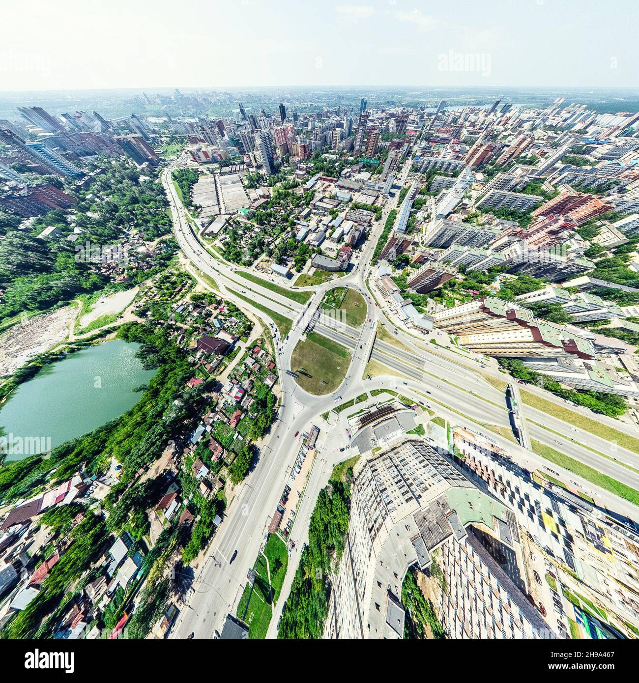 Aerial city view with crossroads and roads, houses, buildings, parks ...