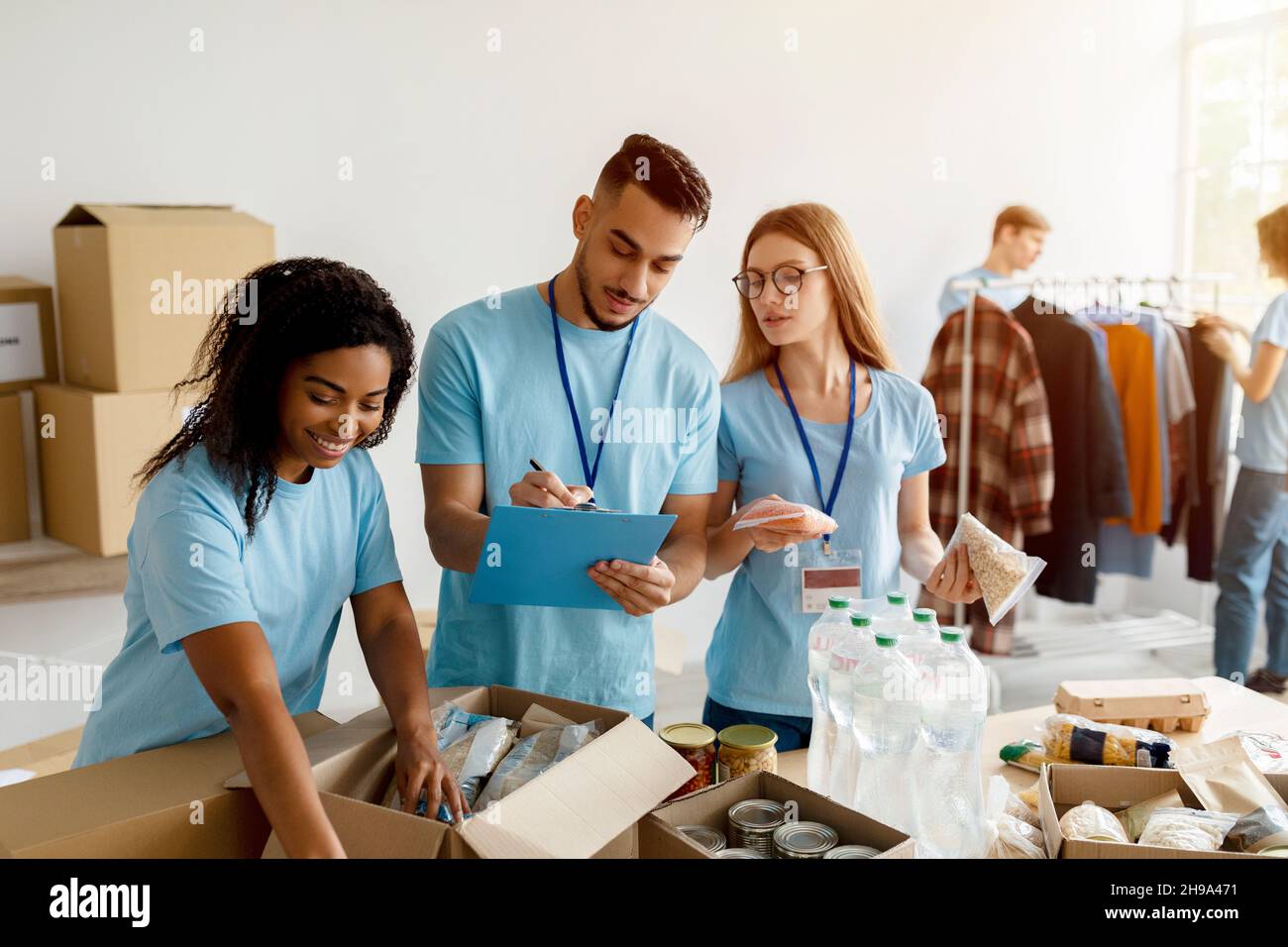 Volunteer work. Young arab male activist checking donation list and ...