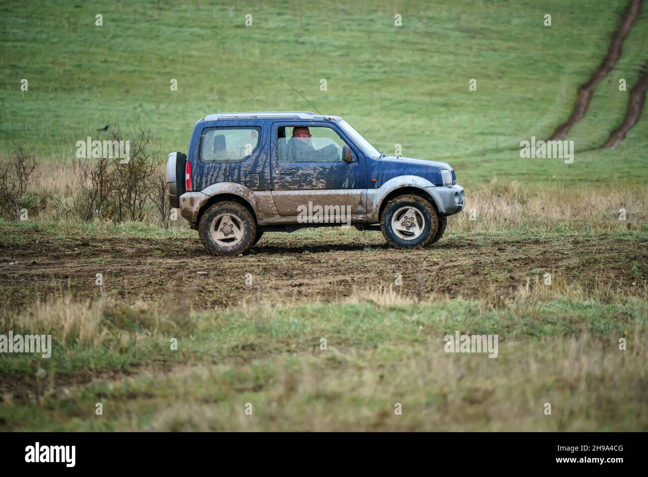 4x4 off-road vehicles driving across mud and water-logged terrain ...