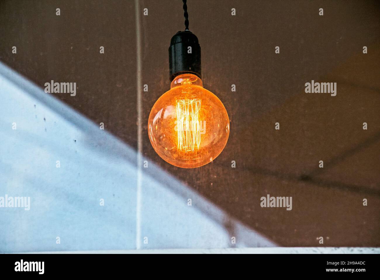 Background image of an outdoor lamp, focus on a classic light bulb with ...