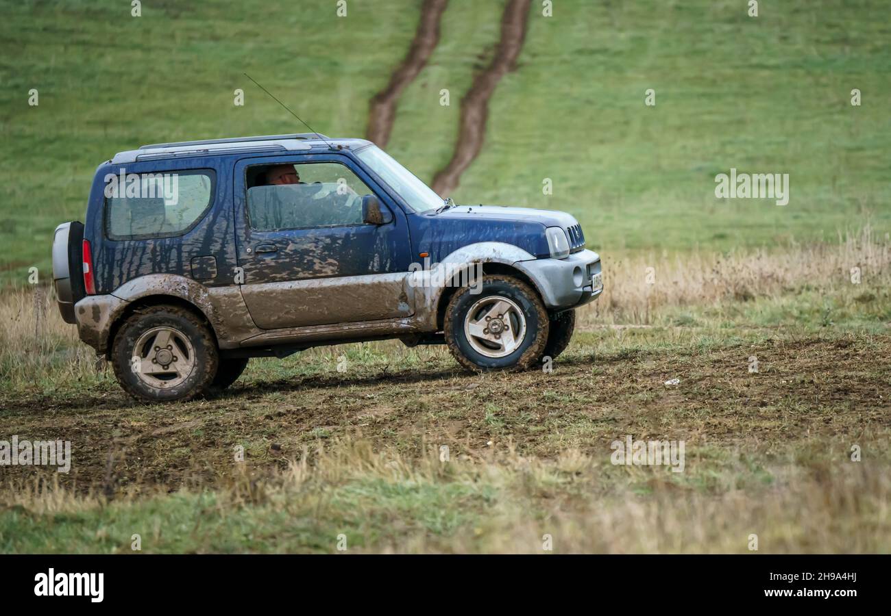 4x4 off-road vehicles driving across mud and water-logged terrain ...