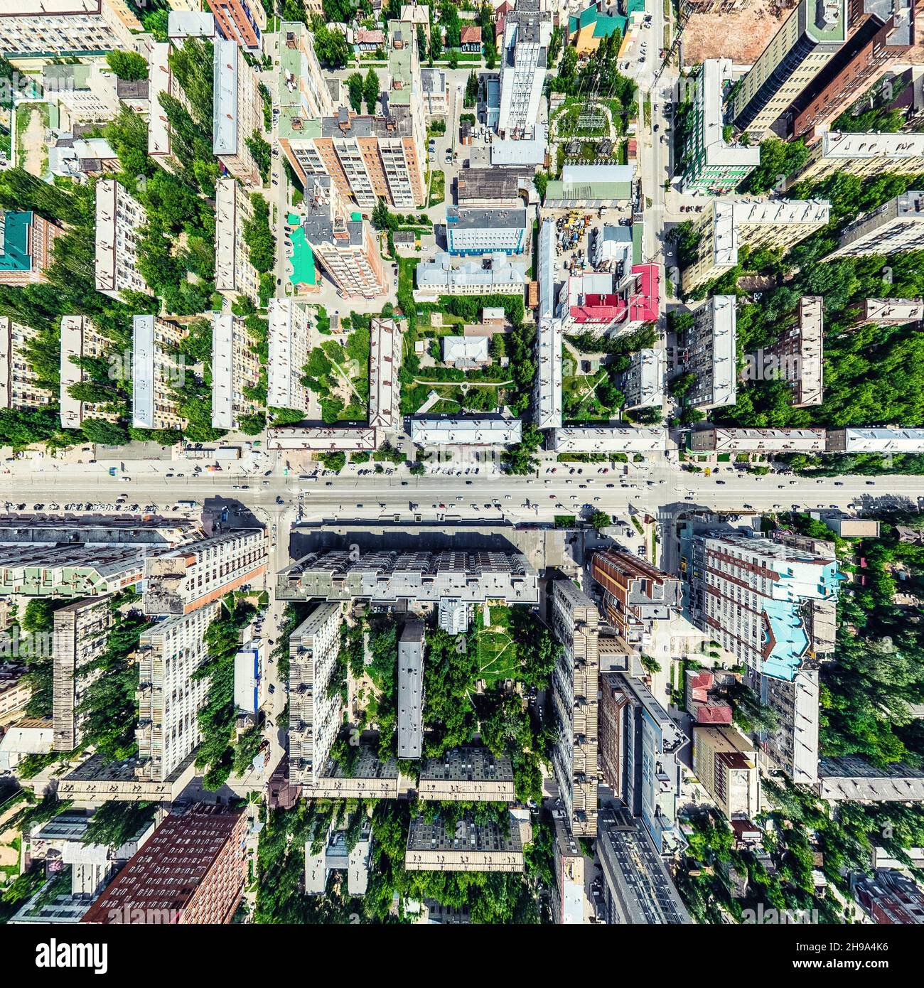 Aerial city view with crossroads and roads, houses, buildings, parks ...