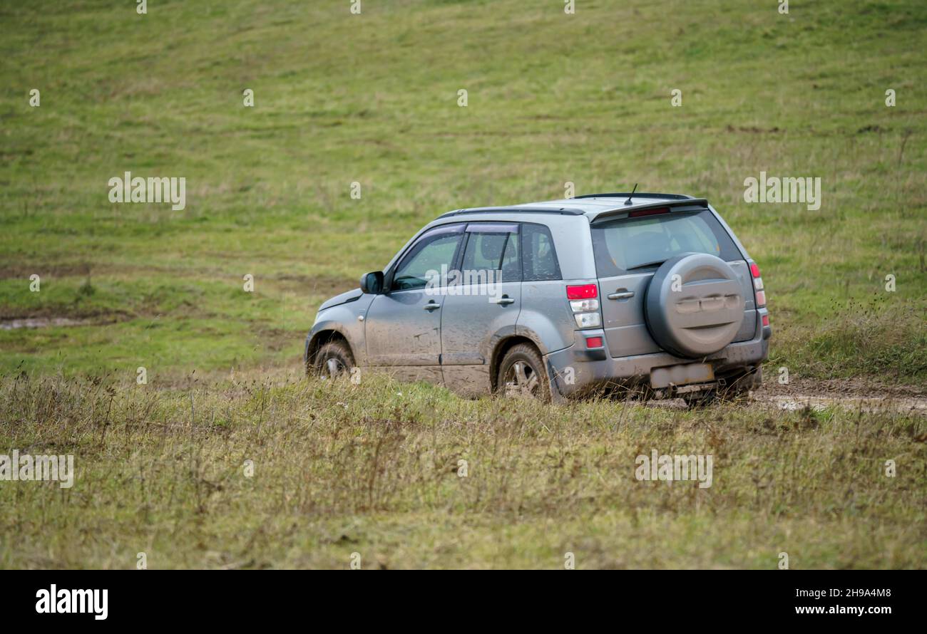4x4 off-road vehicles driving across mud and water-logged terrain ...