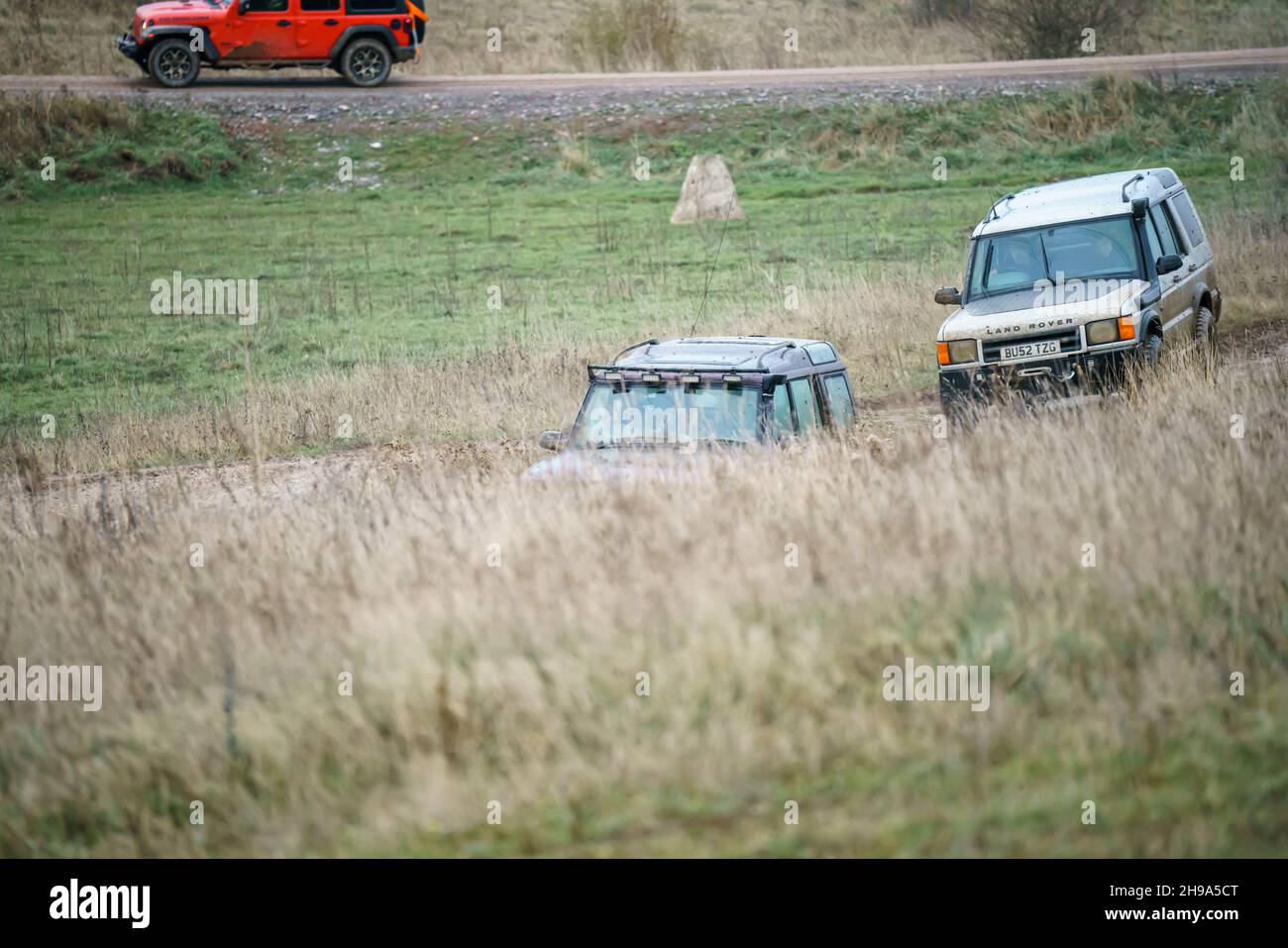 4x4 off-road vehicles driving across mud and water-logged terrain ...