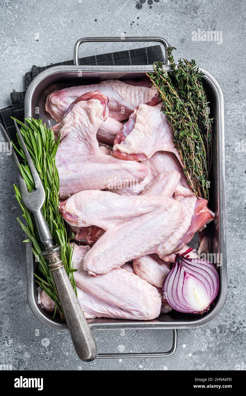 Raw duck wings in a steel tray. Gray background. Top view Stock Photo ...