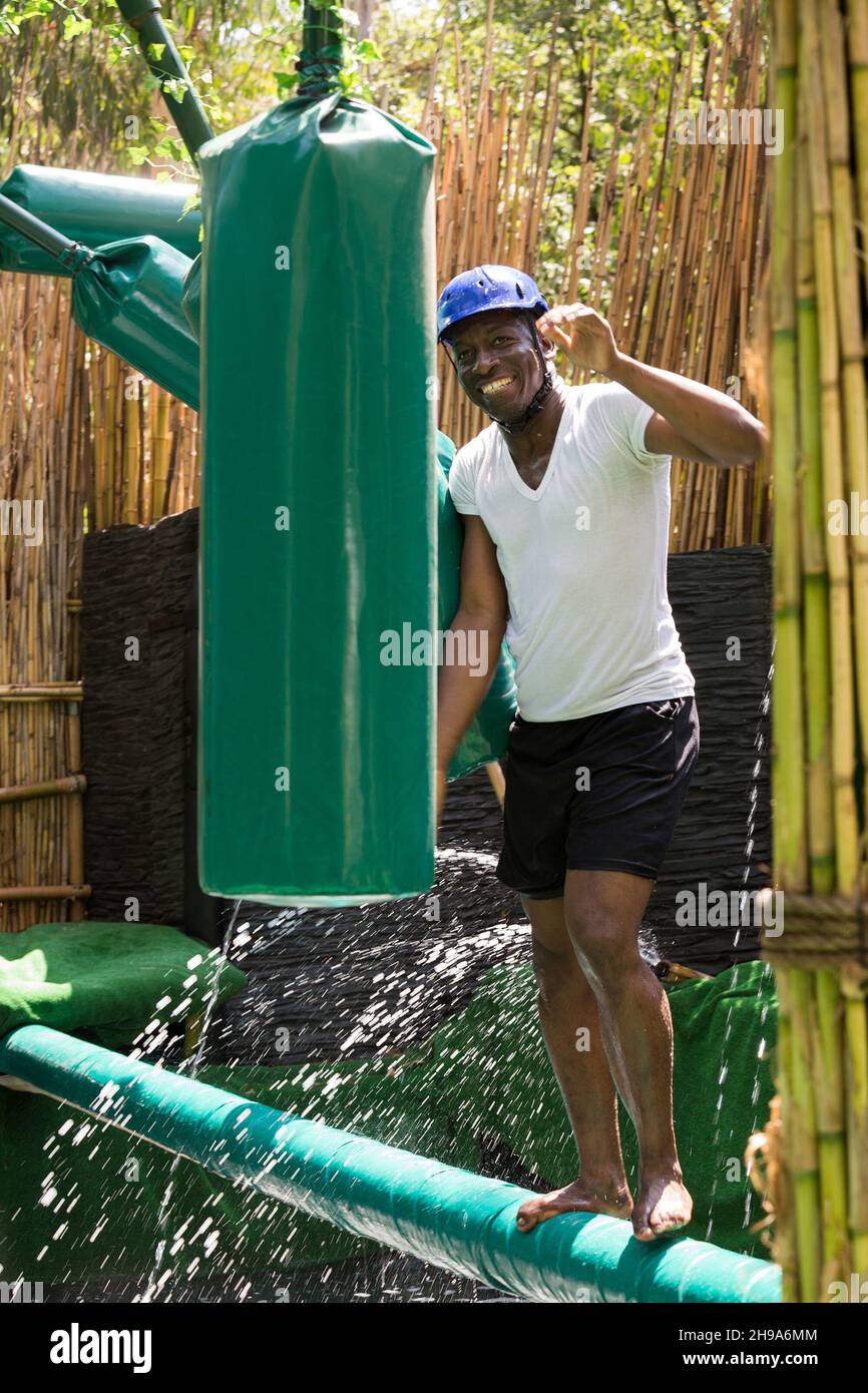 Youth in the amusement park trying to pass through an obstacle course ...