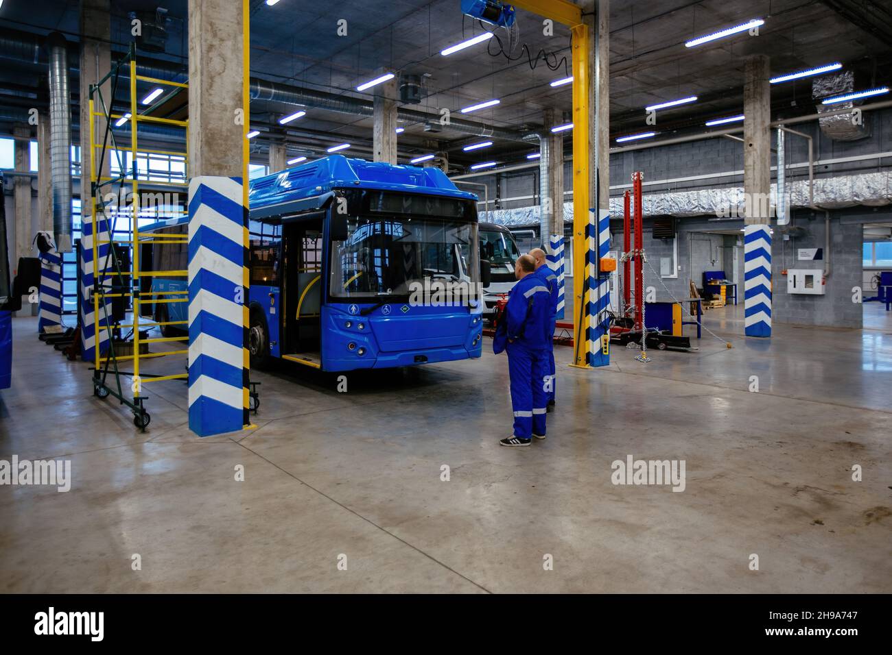 Buses in the modern repair service workshop Stock Photo - Alamy