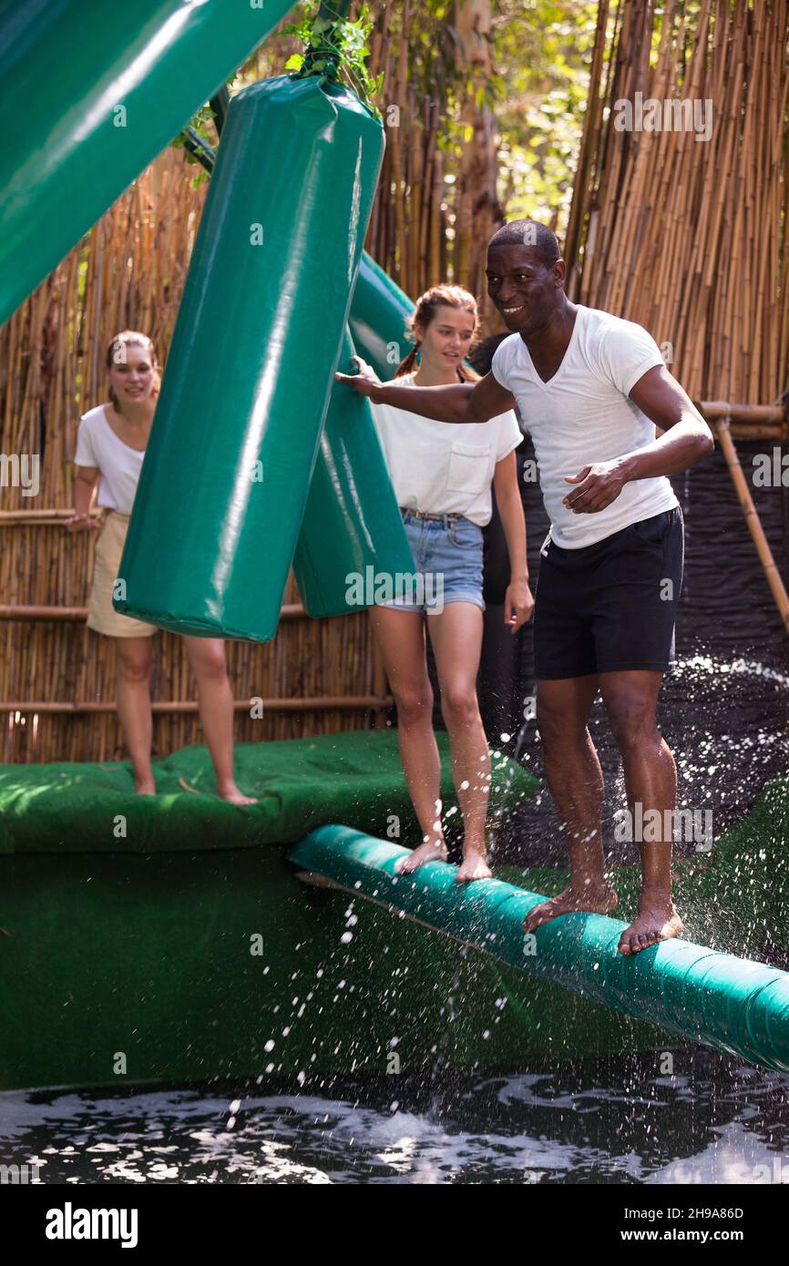 Obstacle course over the water - fun adventure in an amusement park ...