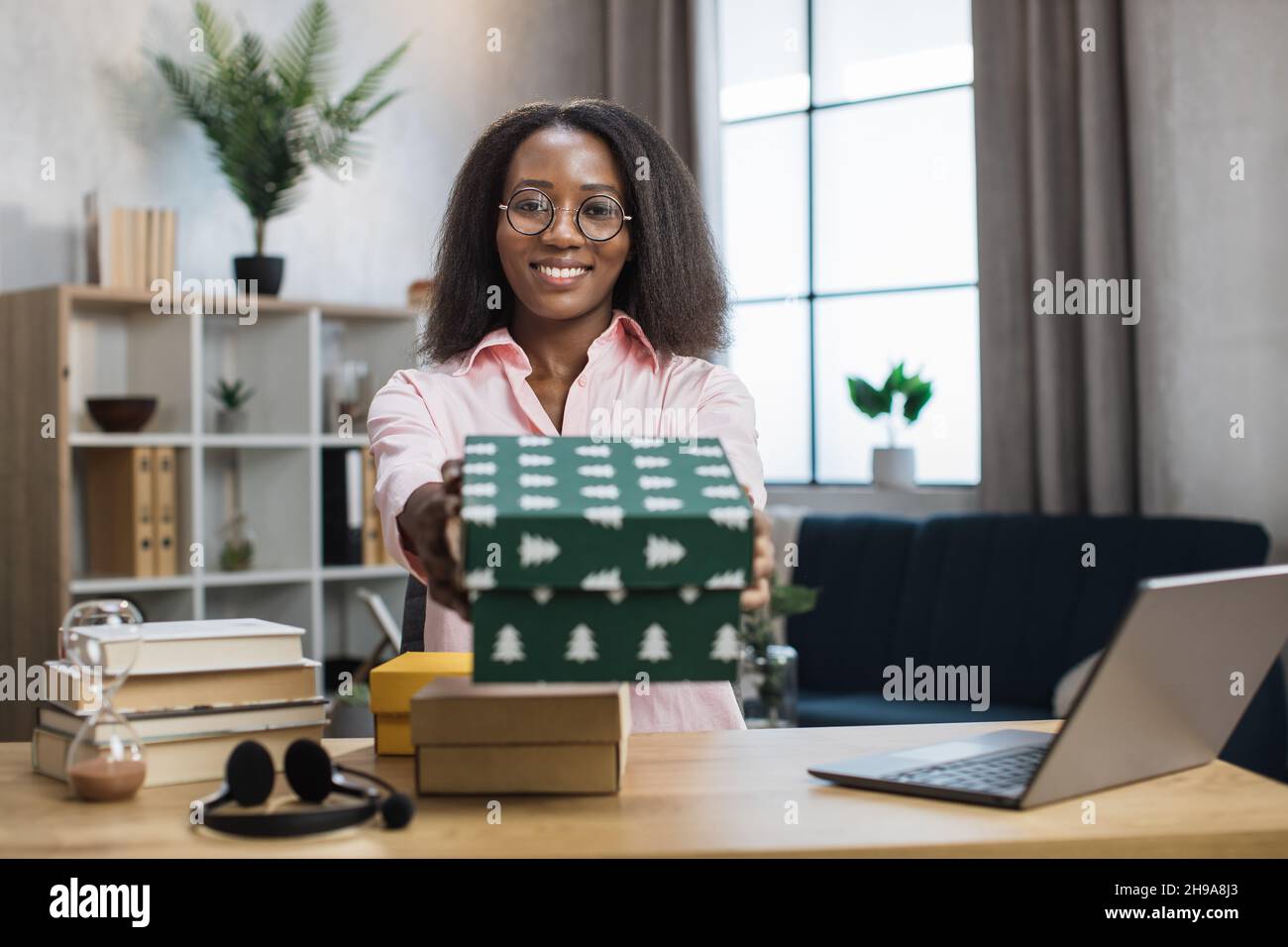 First person view of african female blogger opening gift boxes while ...