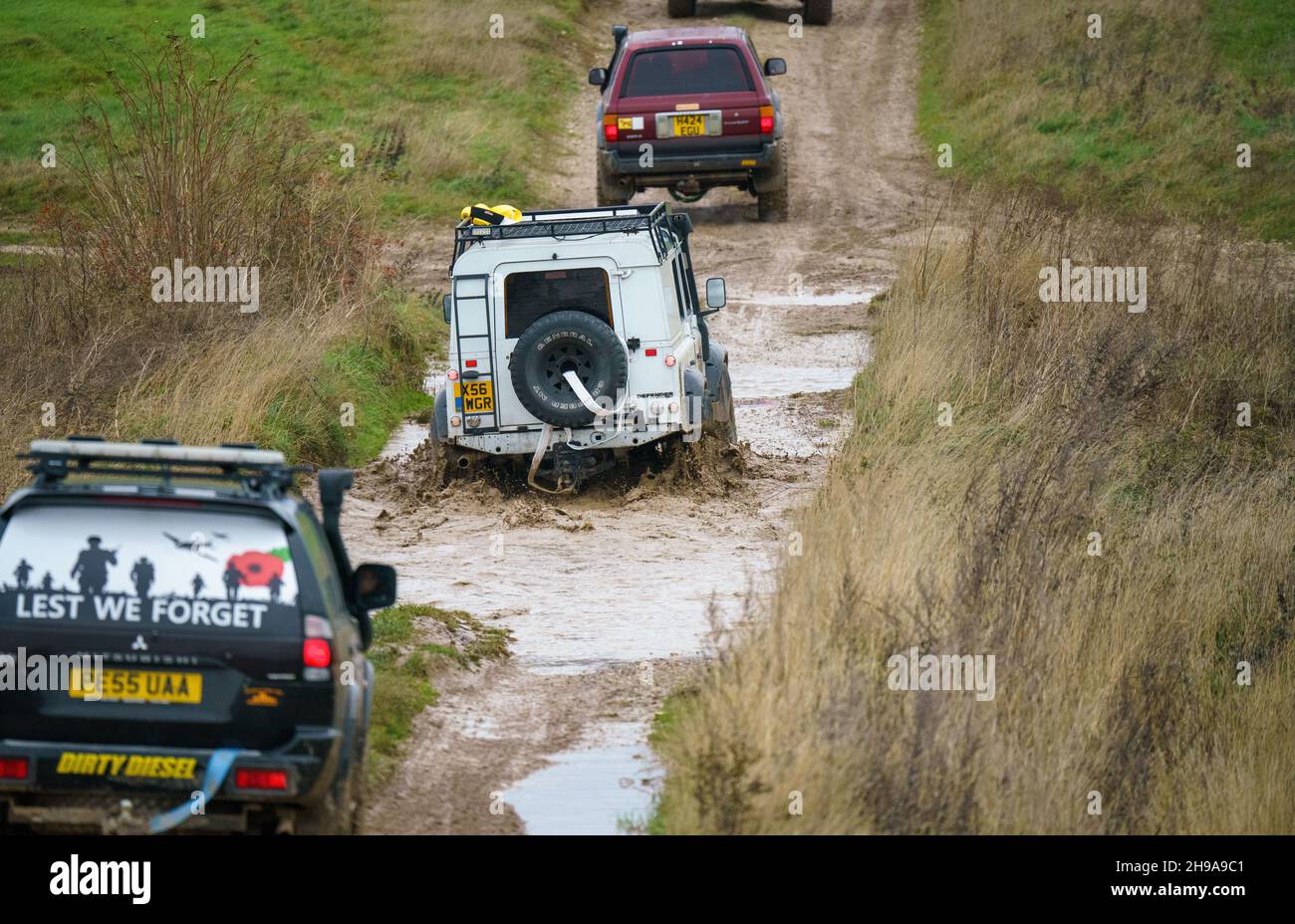 4x4 off-road vehicles driving across mud and water-logged terrain ...