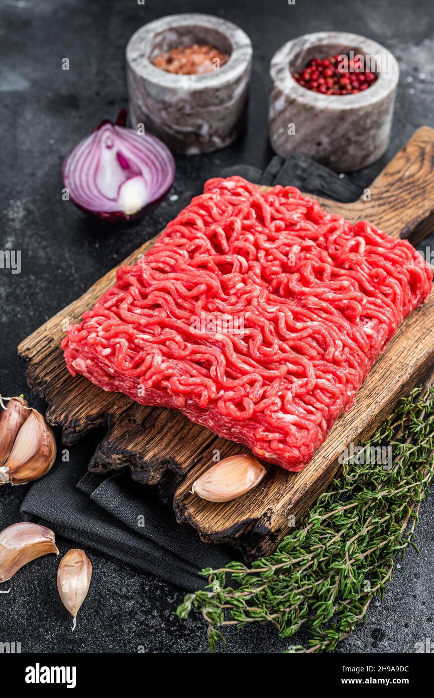 Raw Mince, minced Ground beef meat on a cutting board. Black background ...