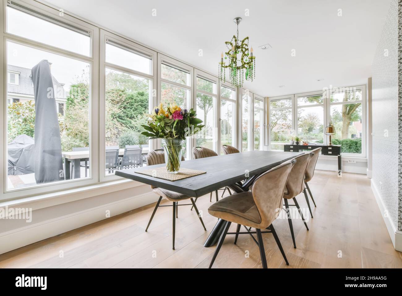 Large dining room with large table and chairs and a full side wall ...