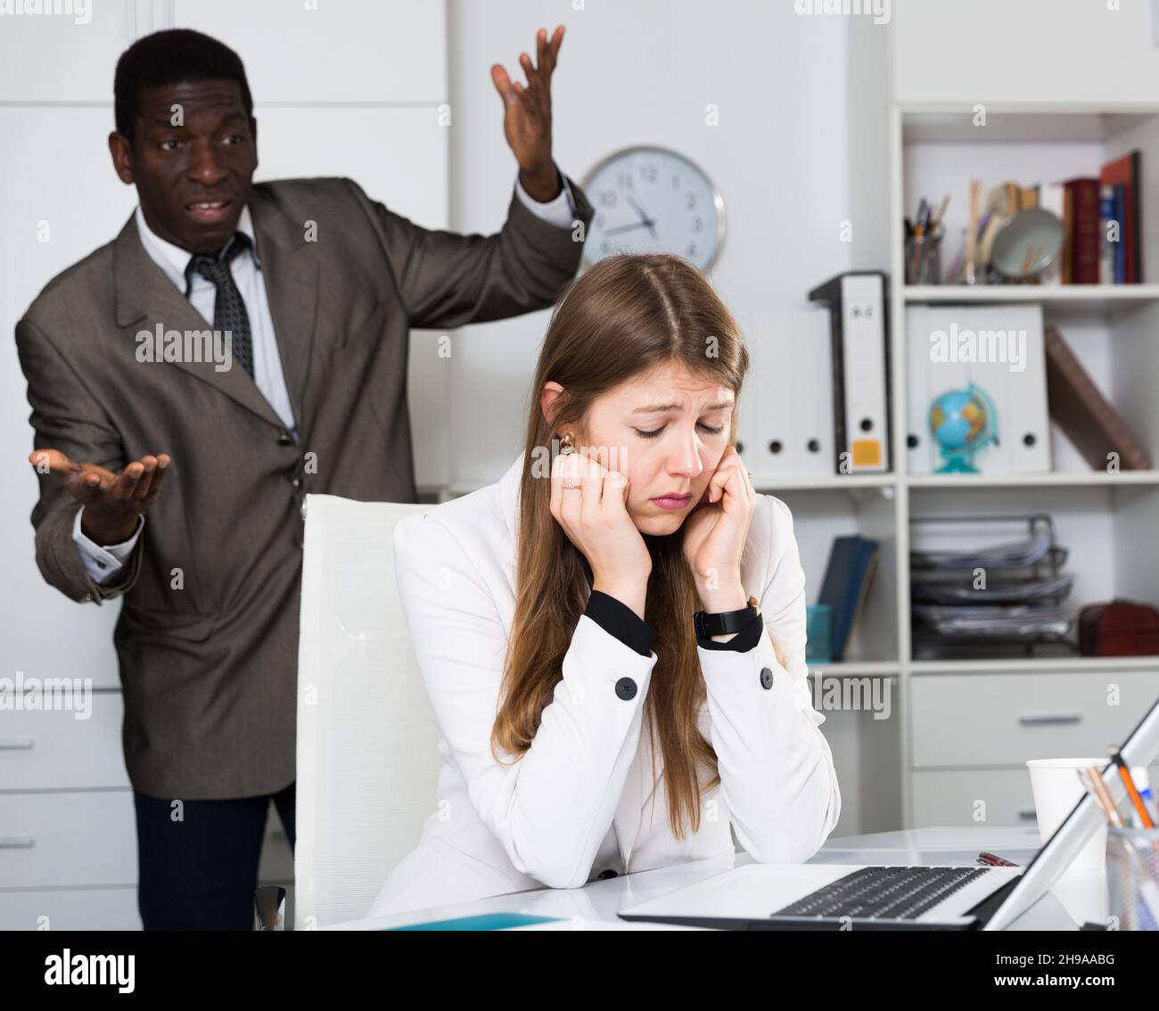 Upset woman with angry boss Stock Photo - Alamy