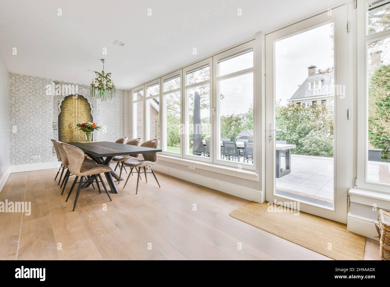 Large dining room with large table and chairs and a full side wall ...
