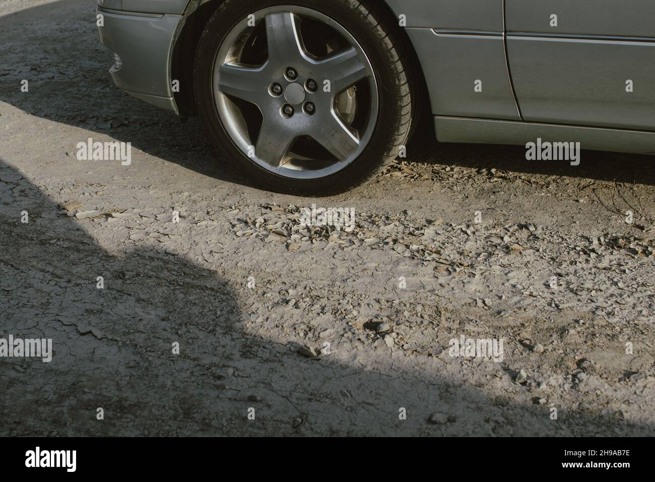Automobile tire of grey car on the off-road at a daytime Stock Photo ...