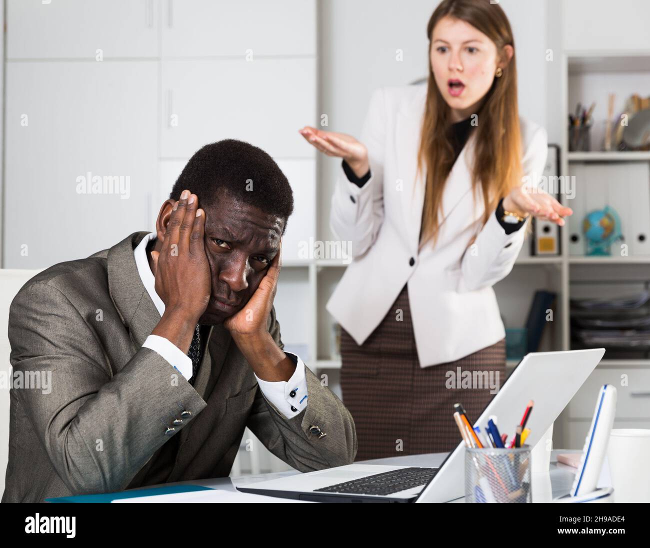 Upset man with angry boss Stock Photo - Alamy