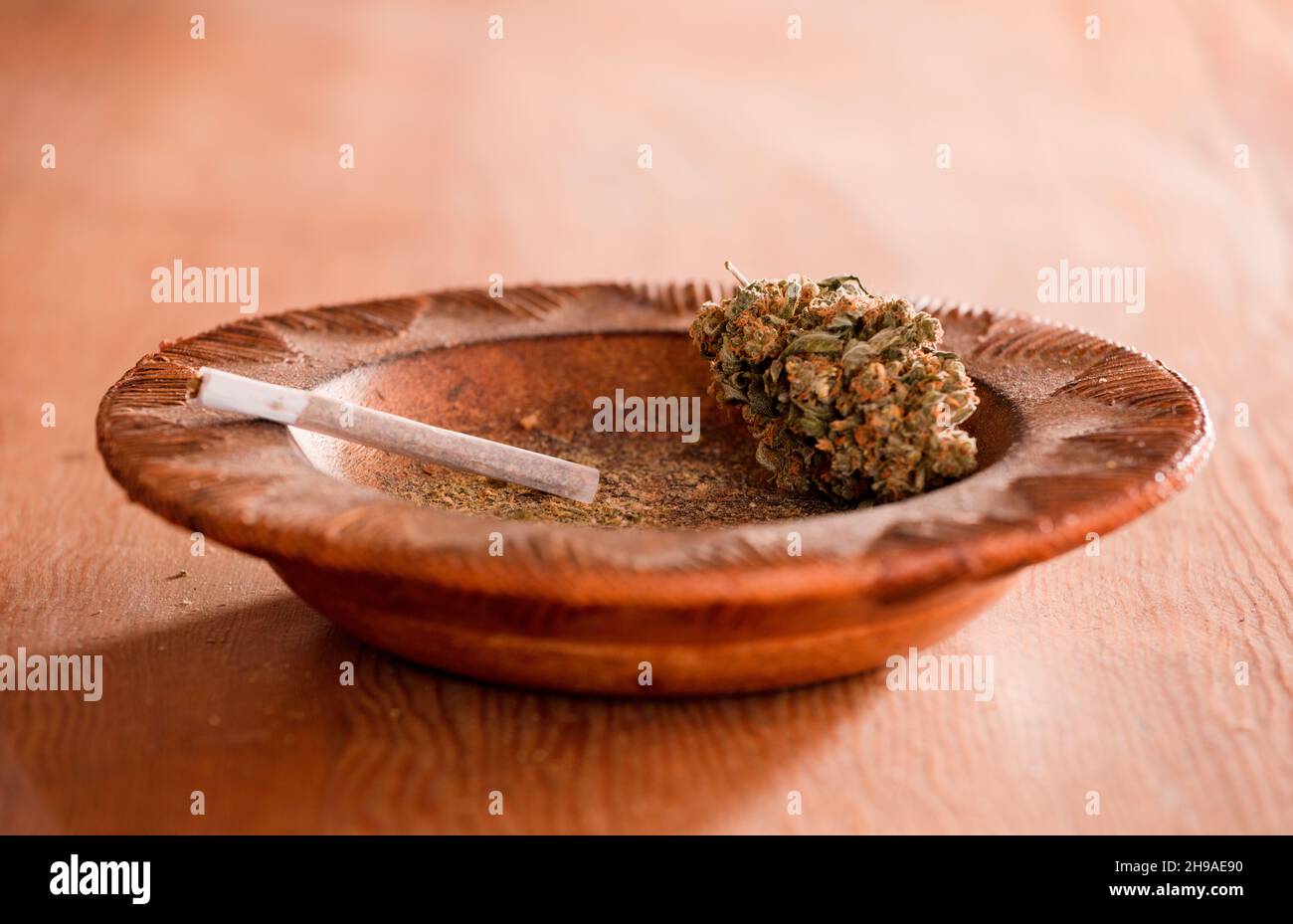wooden container with marijuana cigar and bud, on wooden table Stock ...