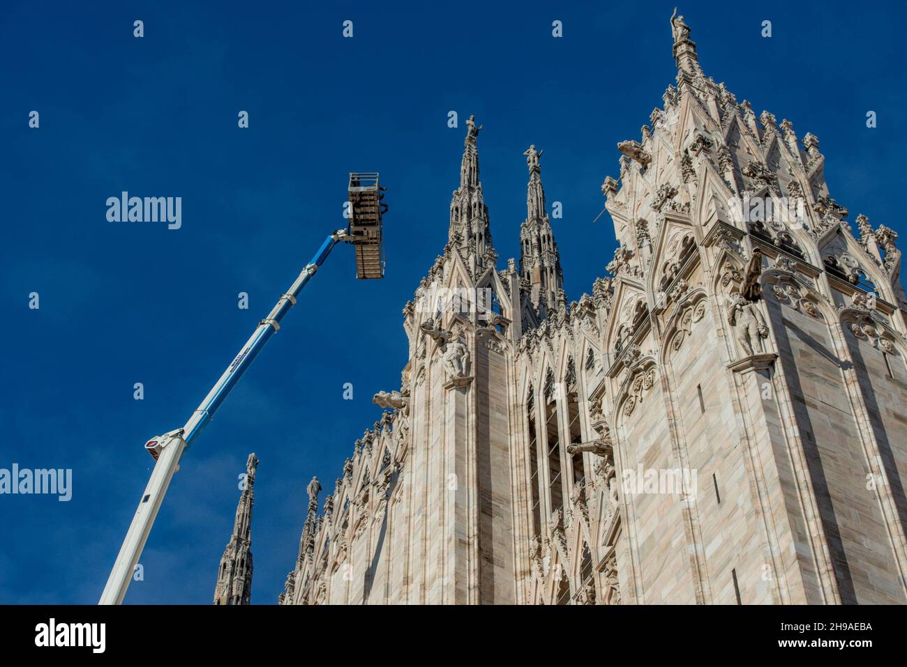 Milan Italy 1 December 2021: Technicians on lifting platform for scheduled maintenance plan and ...