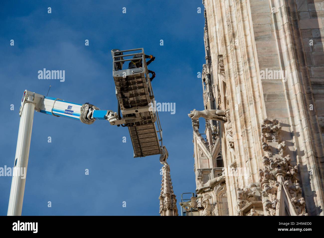 Milan Italy 1 December 2021: Technicians on lifting platform for scheduled maintenance plan and ...