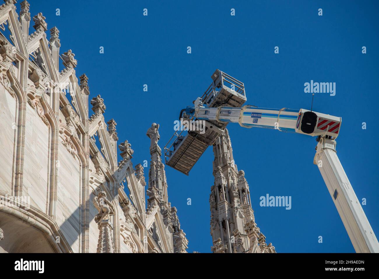 Milan Italy 1 December 2021: Technicians on lifting platform for scheduled maintenance plan and ...