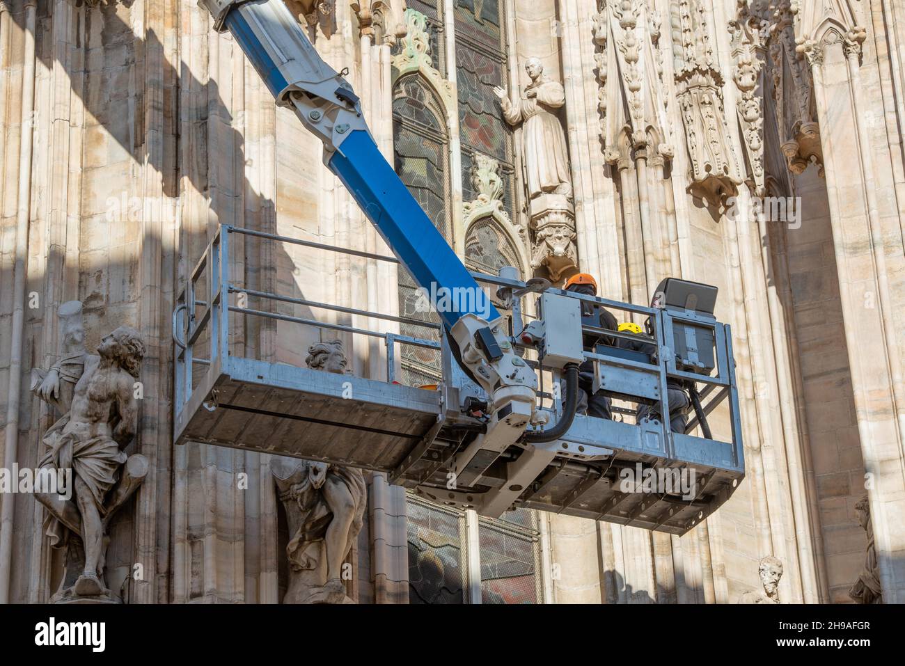 Milan Italy 1 December 2021: Technicians on lifting platform for scheduled maintenance plan and ...