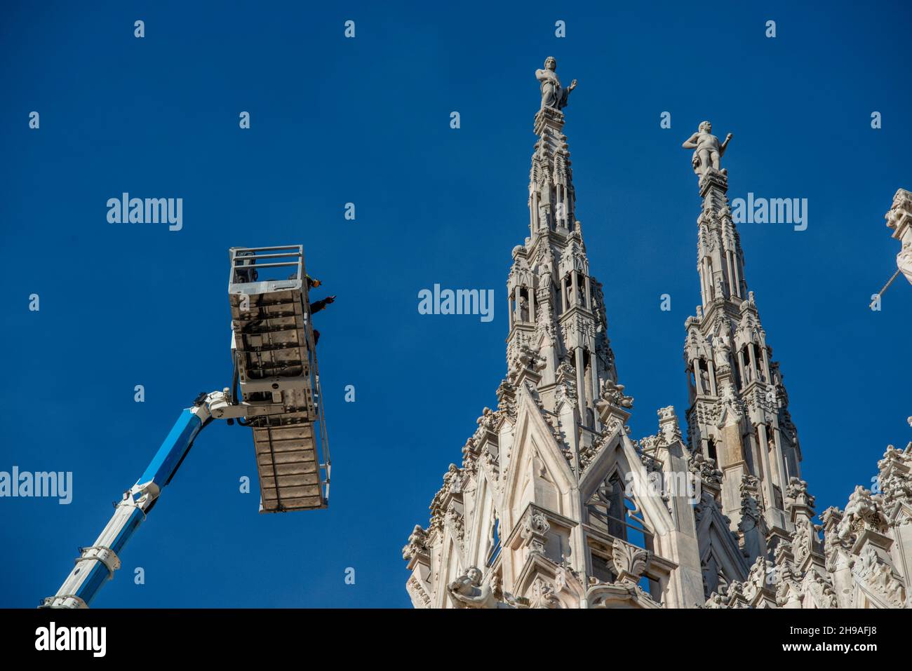 Milan Italy 1 December 2021: Technicians on lifting platform for scheduled maintenance plan and ...