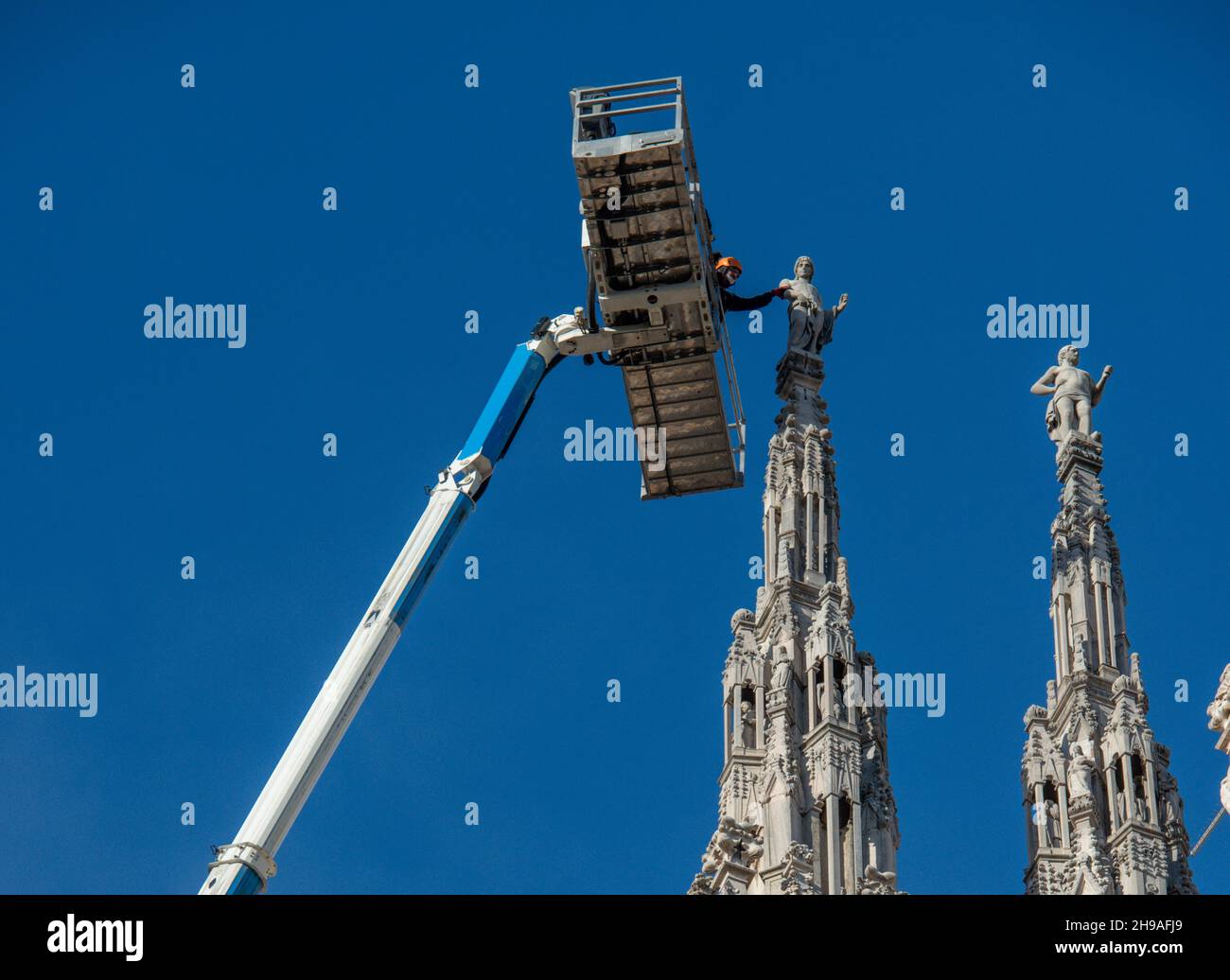 Milan Italy 1 December 2021: Technicians on lifting platform for scheduled maintenance plan and ...