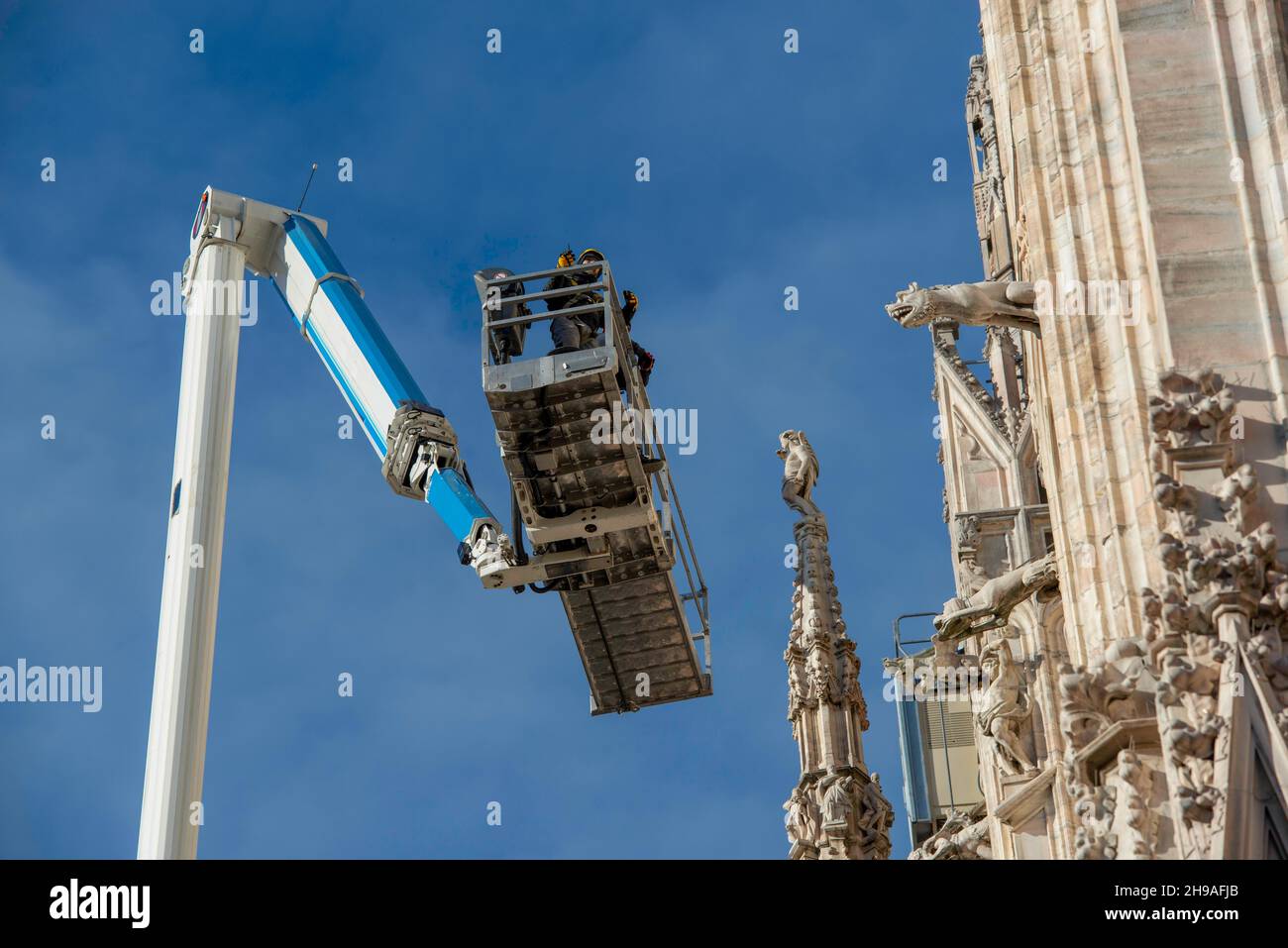 Milan Italy 1 December 2021: Technicians on lifting platform for scheduled maintenance plan and ...