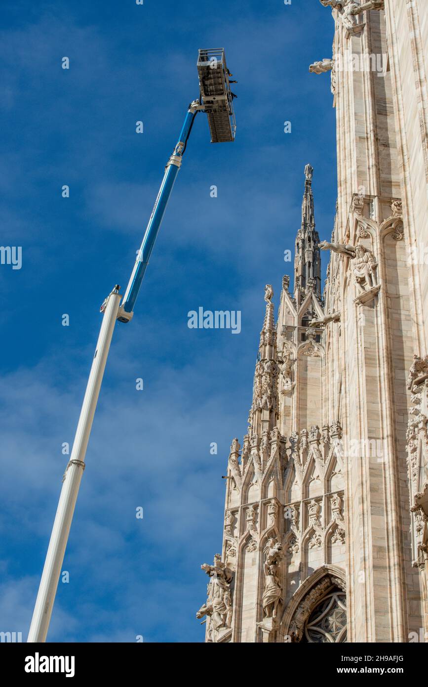 Milan Italy 1 December 2021: Technicians on lifting platform for scheduled maintenance plan and ...