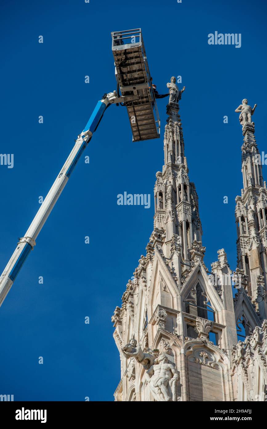 Milan Italy 1 December 2021: Technicians on lifting platform for scheduled maintenance plan and ...