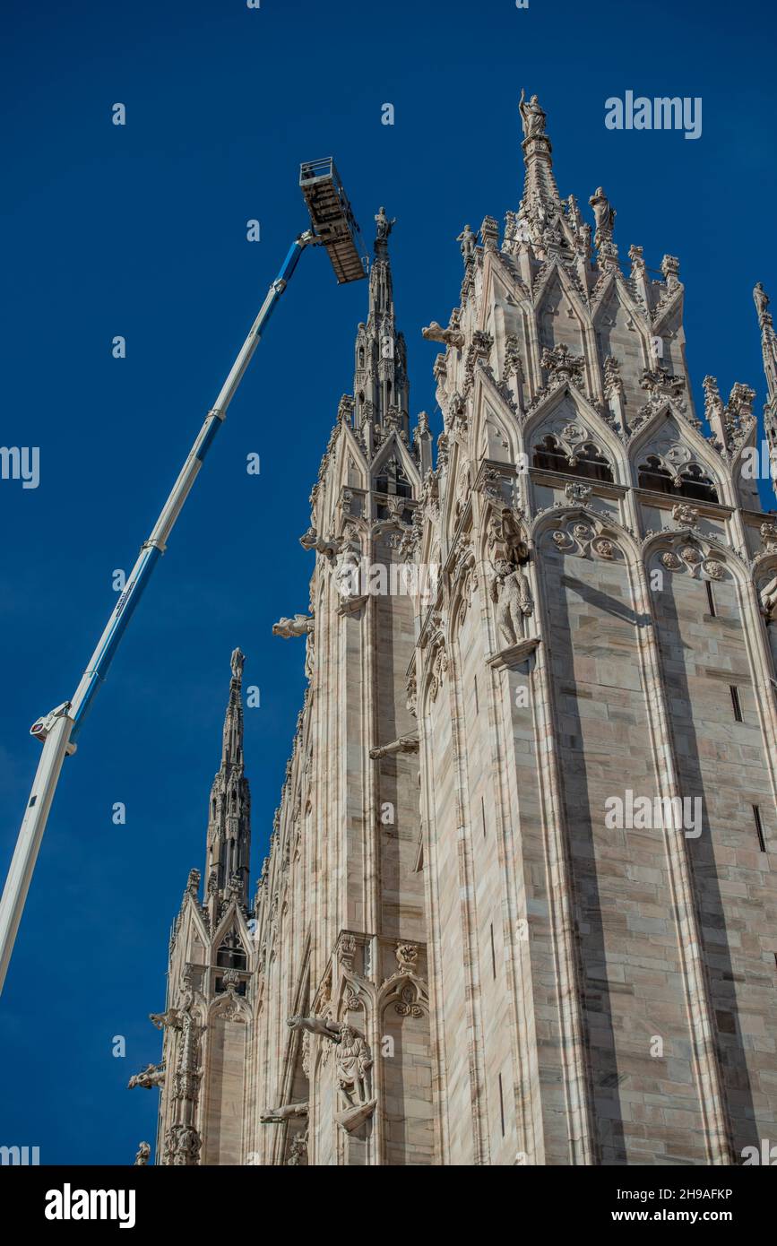 Milan Italy 1 December 2021: Technicians on lifting platform for scheduled maintenance plan and ...