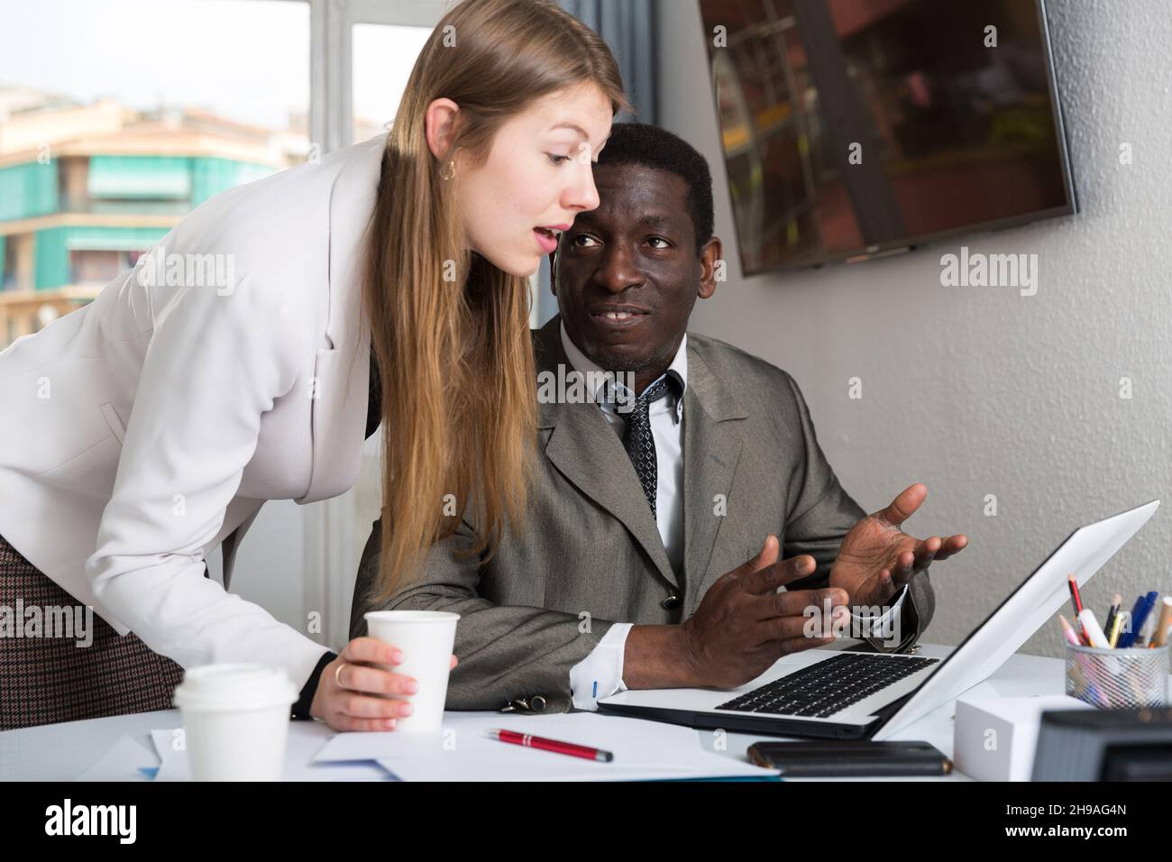 Friendly coworkers working together Stock Photo - Alamy