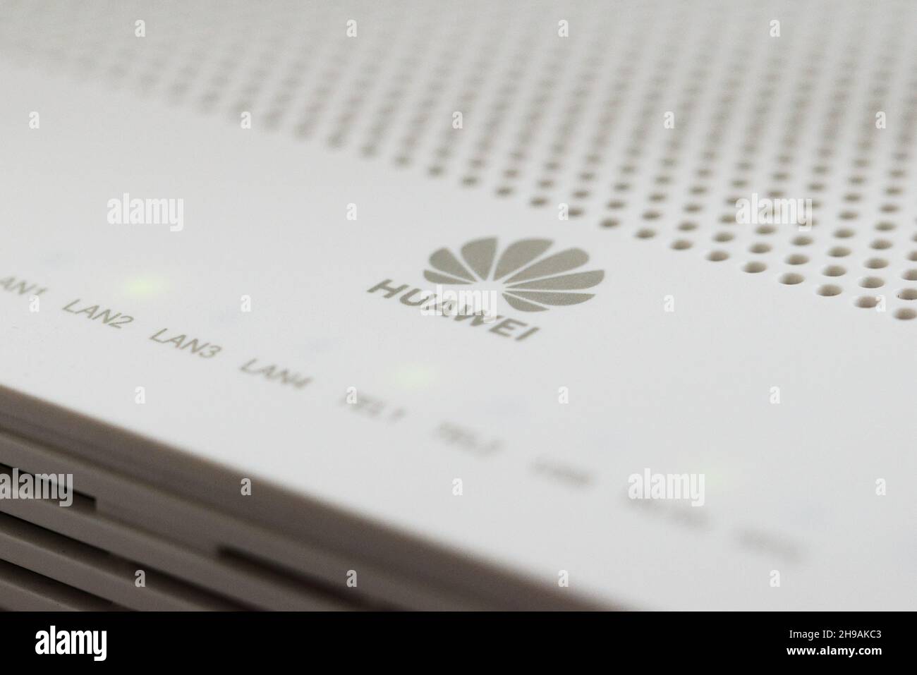 Huawei brand logo on the white plastic case of a modem router. Close up ...