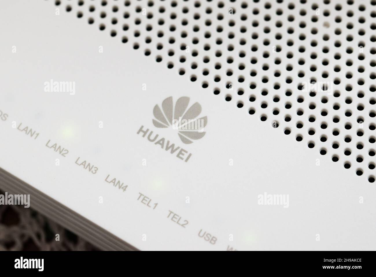 Huawei brand logo on the white plastic case of a modem router. Close up ...