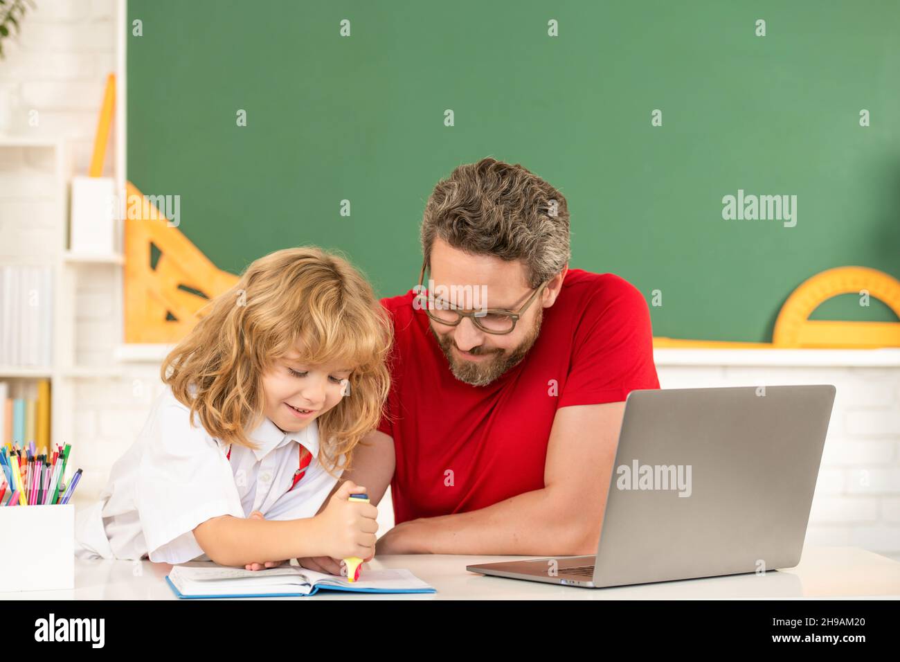 father and child study in classroom with laptop, knowledge Stock Photo ...