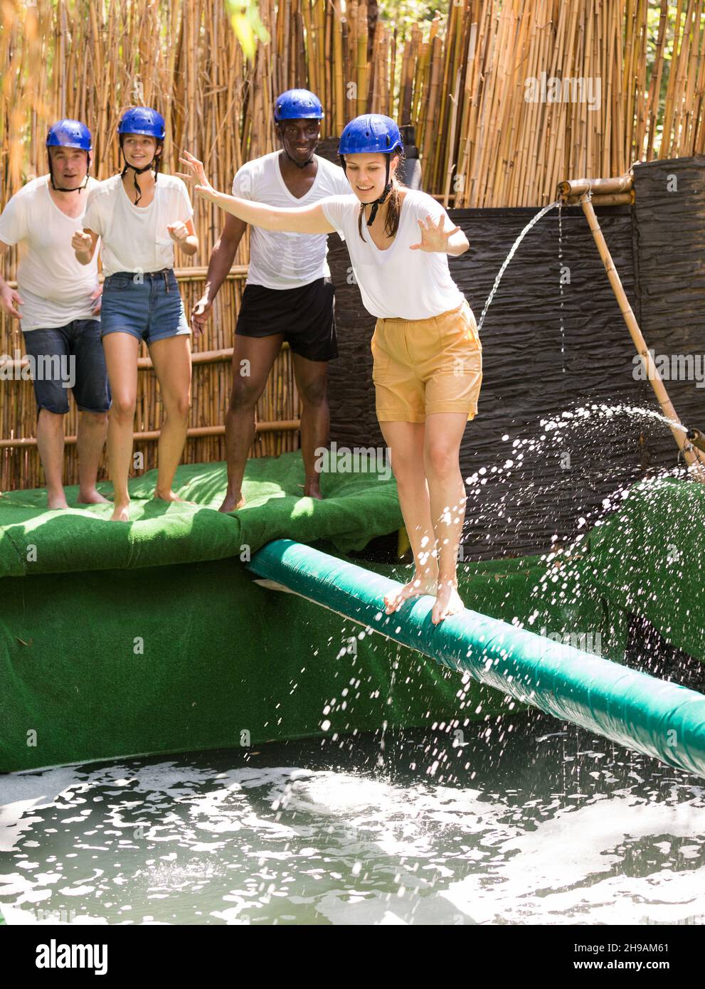 Youth in the amusement park trying to pass through an obstacle course ...