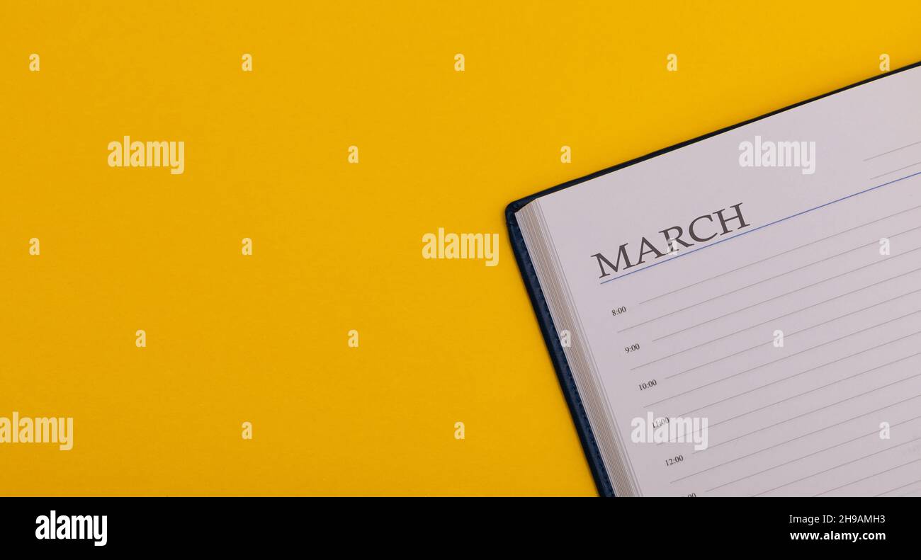 Notepad or diary on a yellow background. Calendar for March. Spring ...