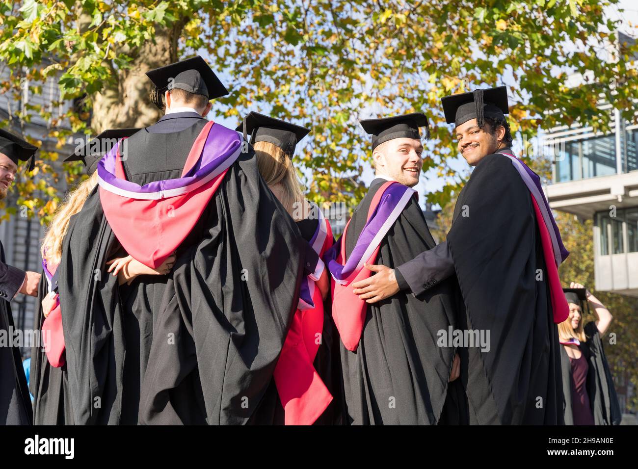 New University graduates line up for a photo shoot at the ceremony ...