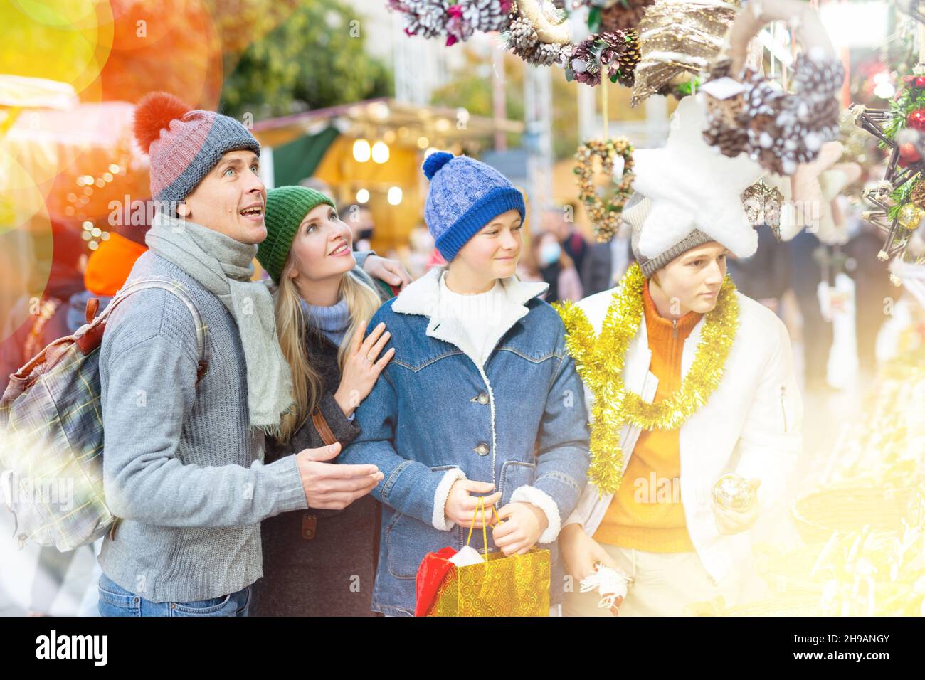 Happy family purchasing christmas decorations Stock Photo - Alamy