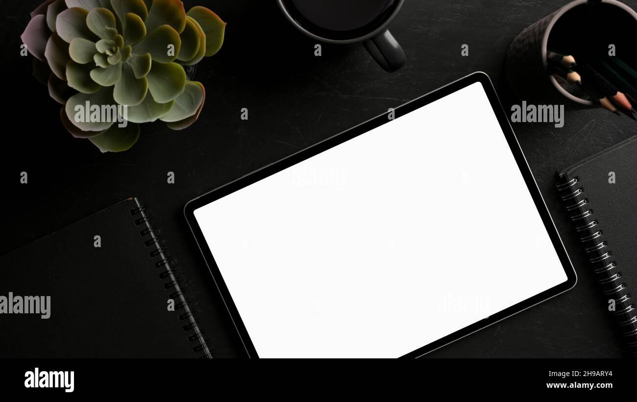 Portable tablet computer with white screen mockup and accessories on ...